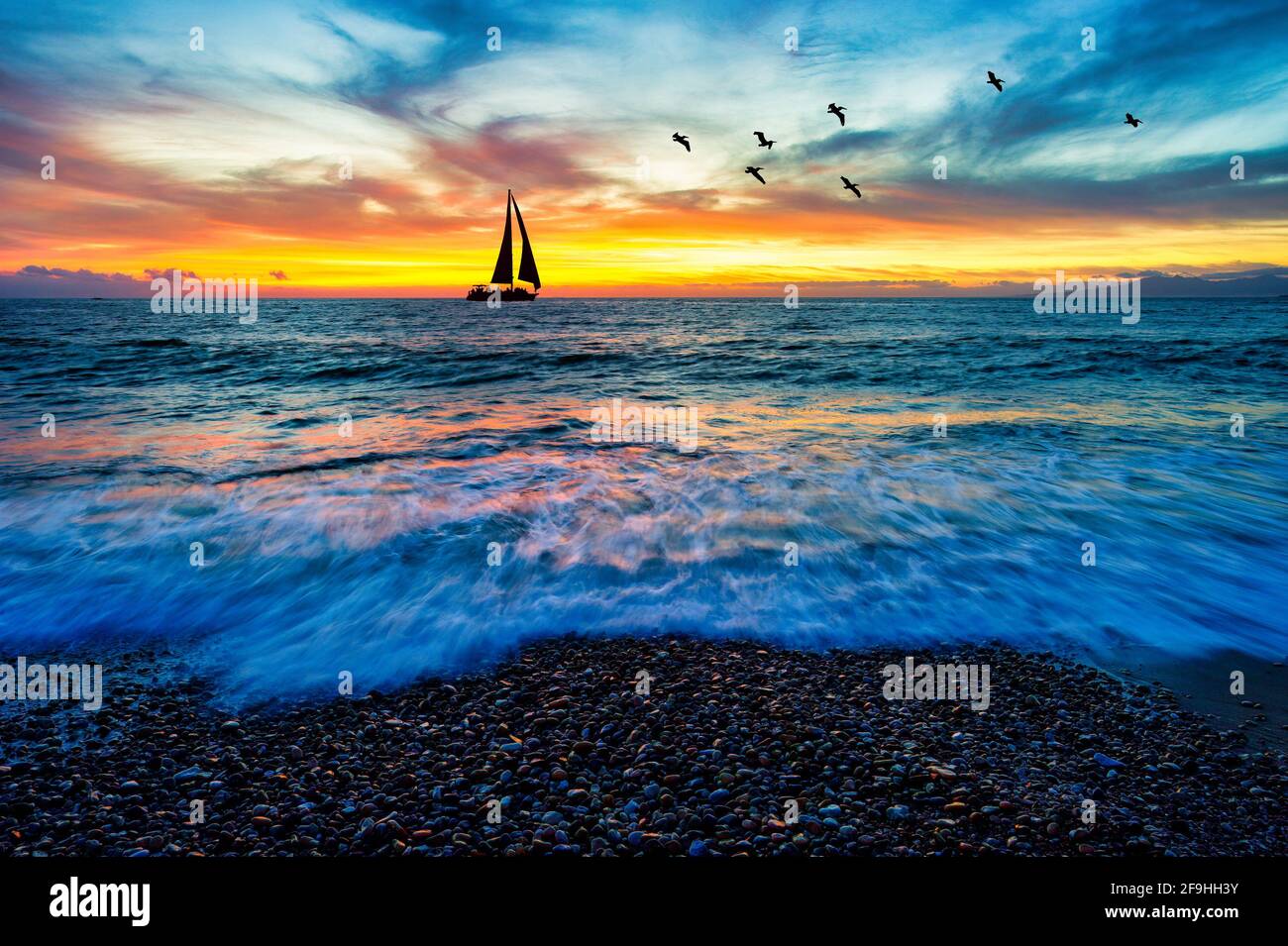 A Colorful Ocean Sunset Sky as a Gentle Wave Rolls to Shore Stock Photo ...
