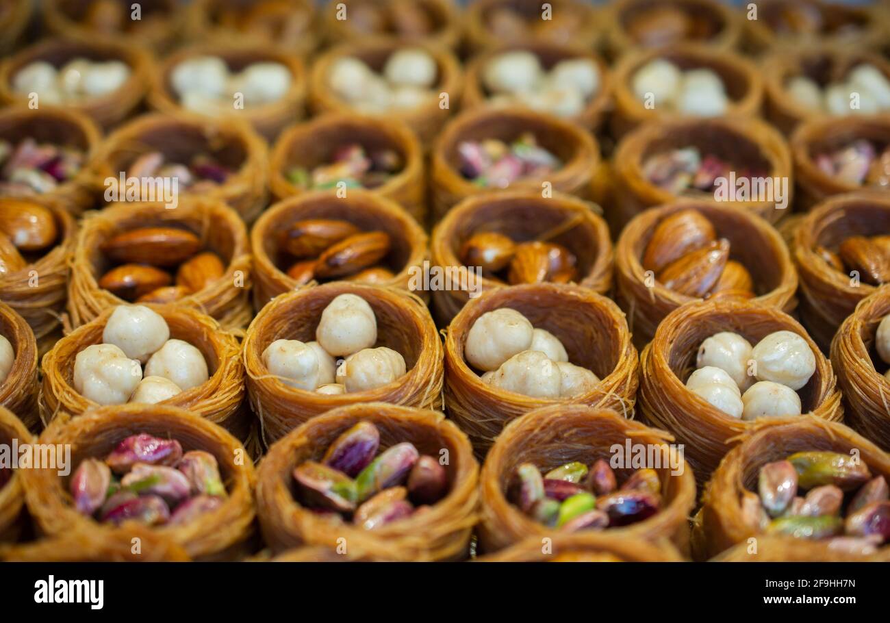 Turkish traditional dessert Kadayif baked in syrup served with nut ...