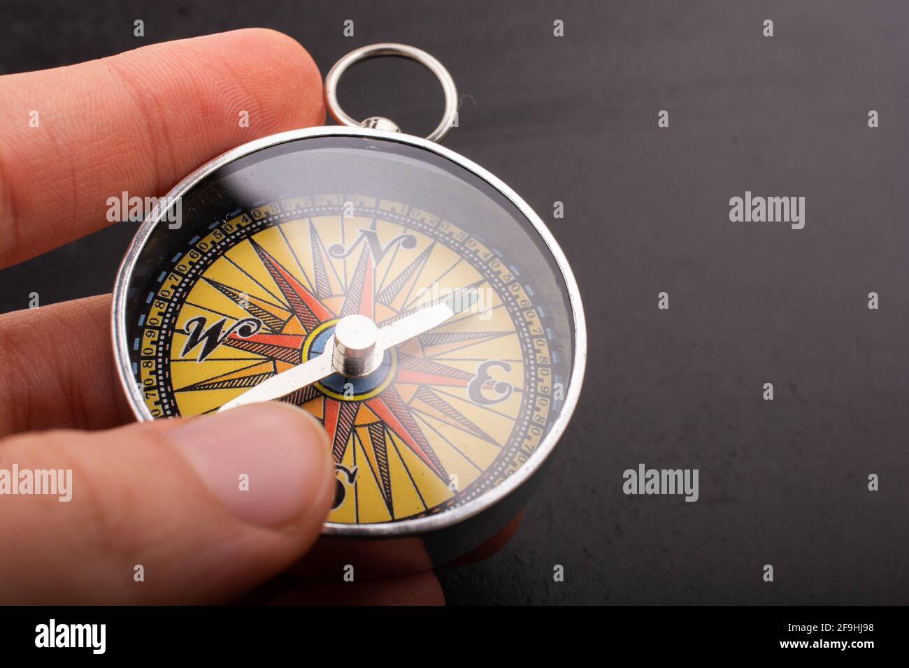 Compass in hand as symbol of tourism and outdoor activities with ...