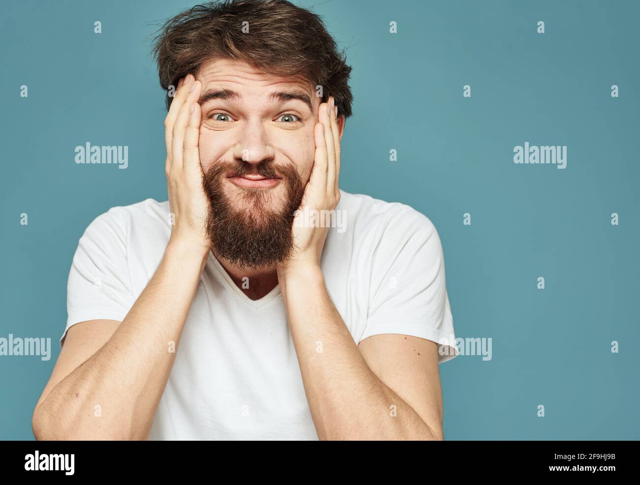 joyful man touching his head with his hands happiness emotions blue ...