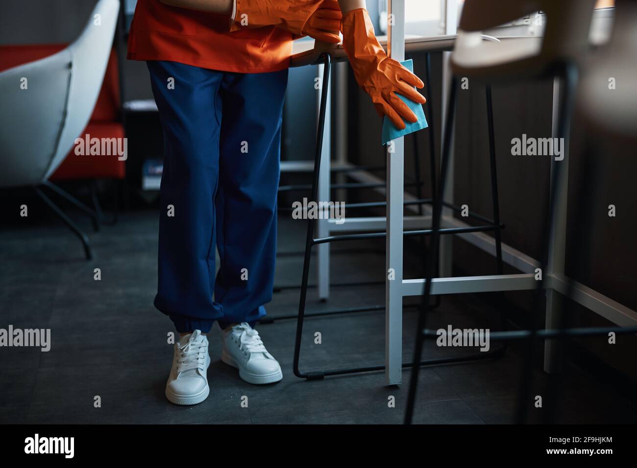 Professional female cleaner doing the cleaning in the cafeteria Stock ...