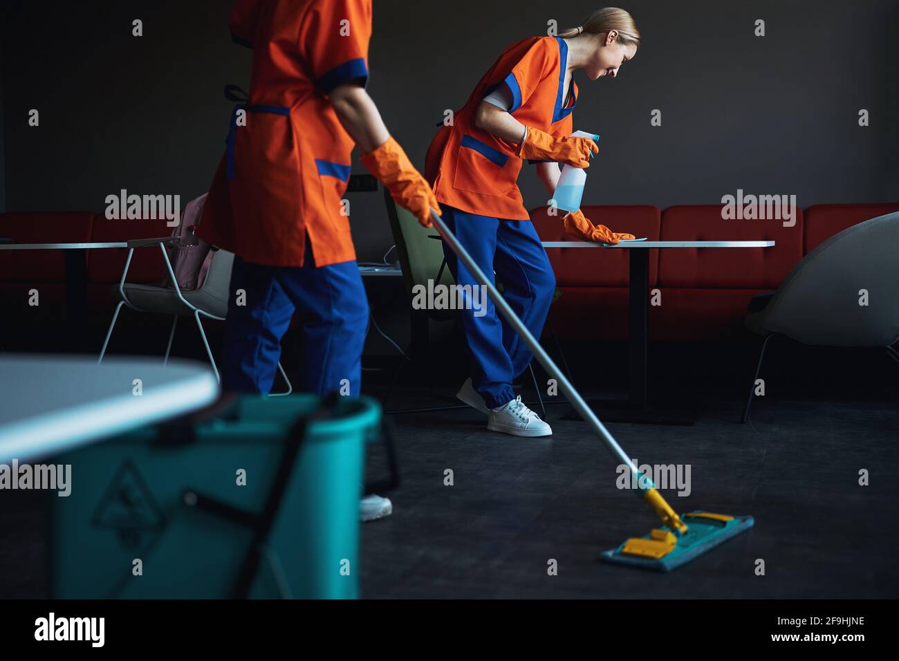 Two professional cleaners tidying up the office cafeteria Stock Photo ...