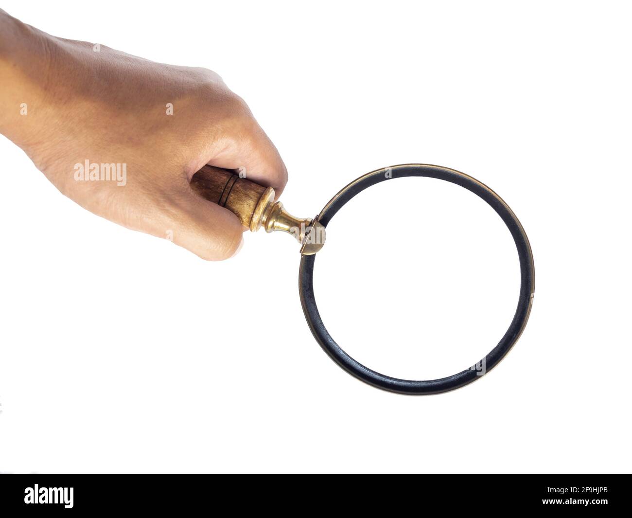 Hand holding old vintage magnifying glass isolated on white background ...