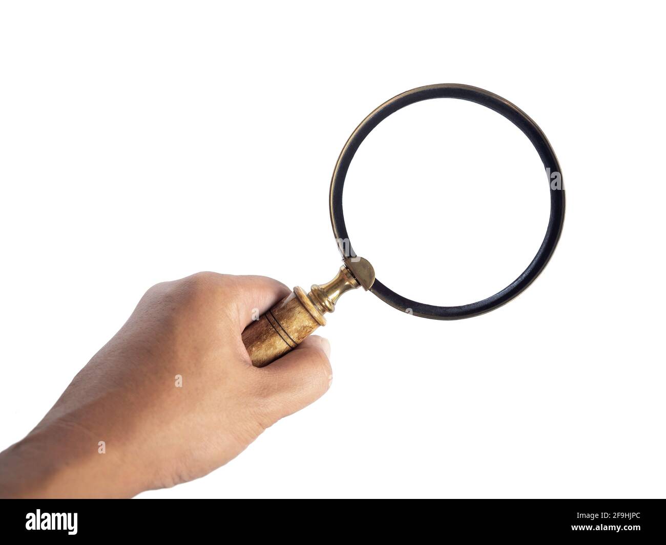 Hand holding old vintage magnifying glass isolated on white background ...