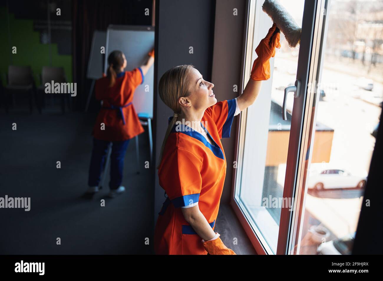 Cheerful cleaner colleague doing hi-res stock photography and images ...