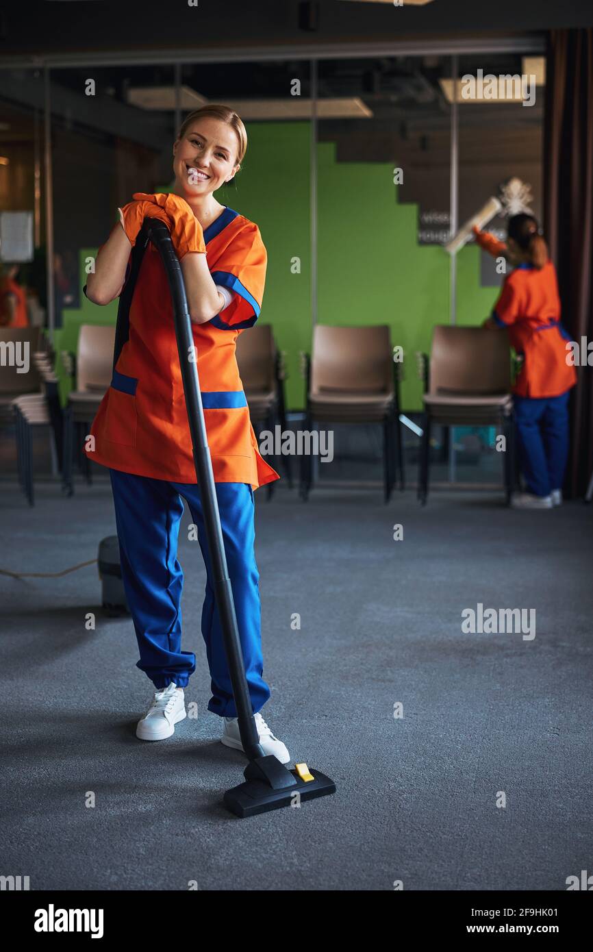 Smiling cleaning lady posing for the camera during the clean-up Stock ...