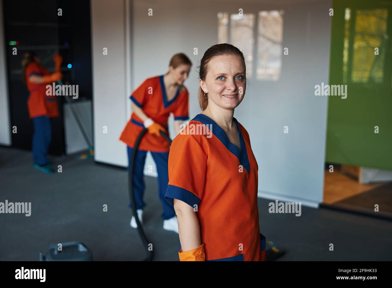 Three professional cleaners cleaning the conference room Stock Photo ...