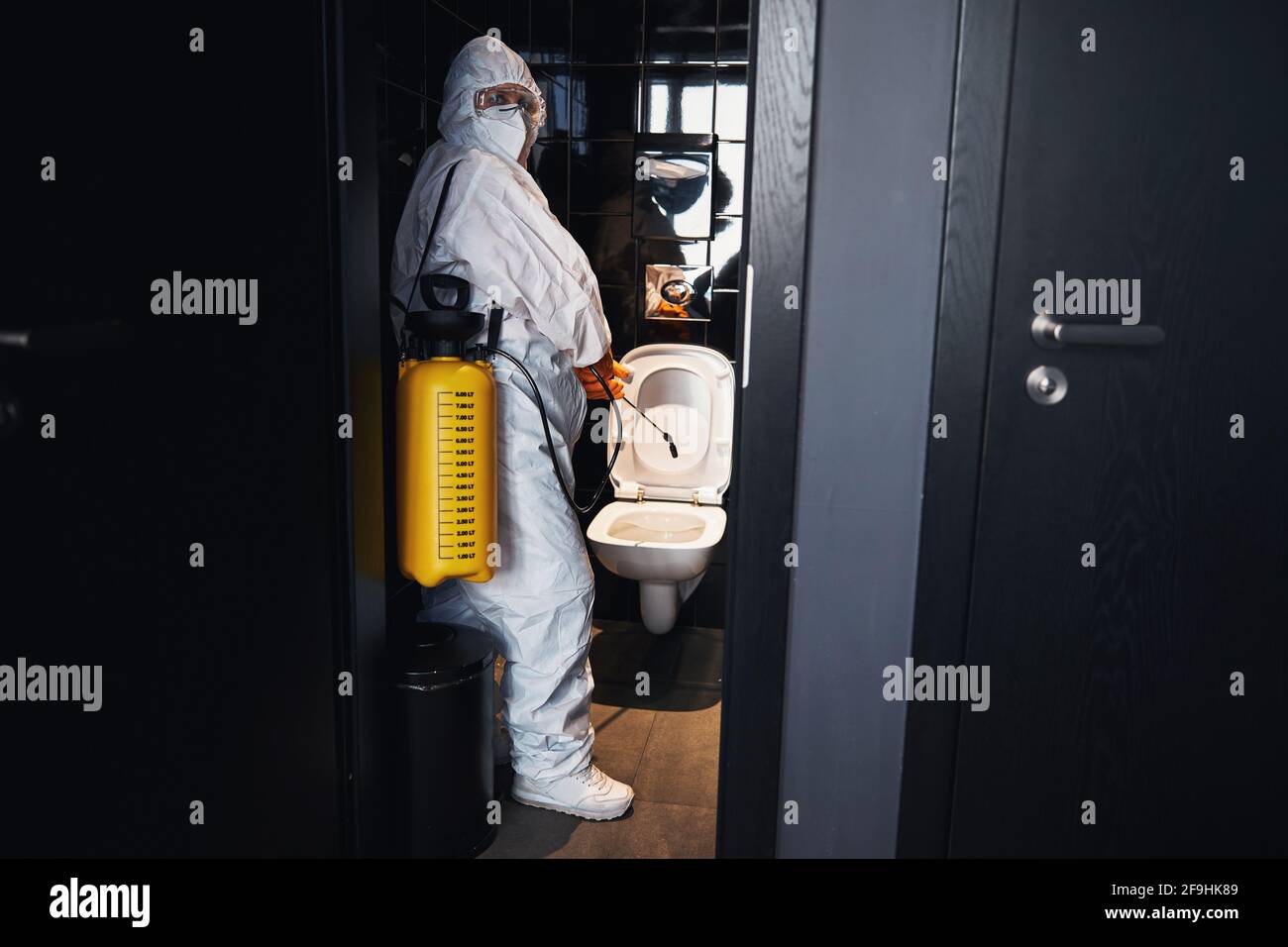 Worker in hazmat suit sanitizing hi-res stock photography and images ...