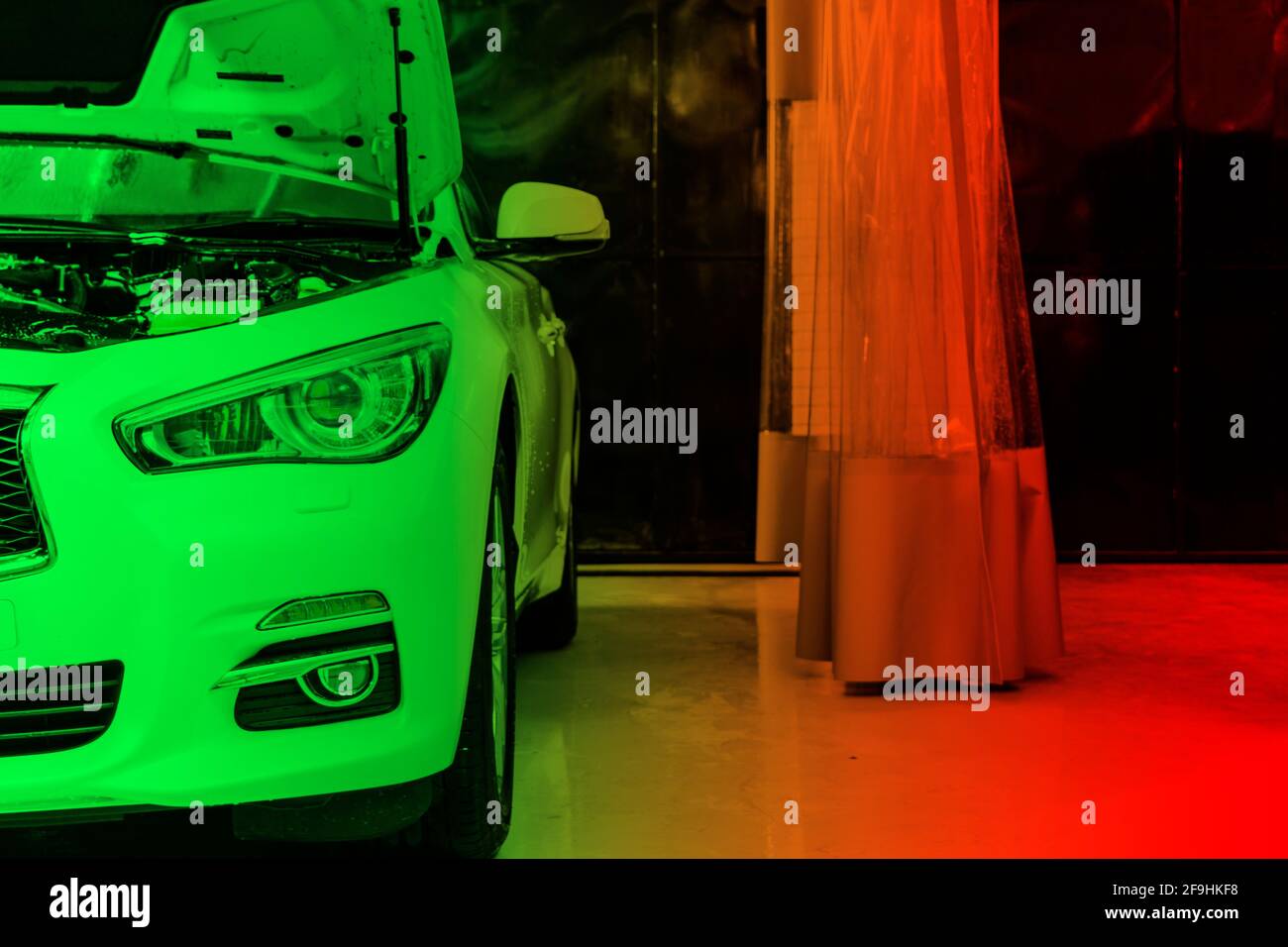 Abstract red and green tones cars in a carwash. Car wash with foam in ...