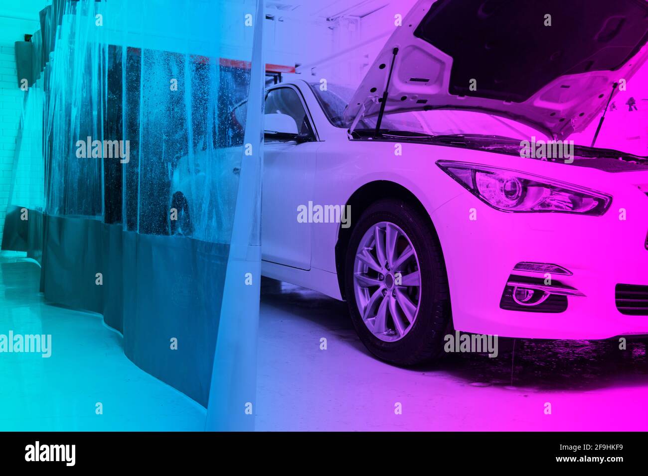 Cars in a carwash in blue an pink tones. Car wash with foam in car wash ...