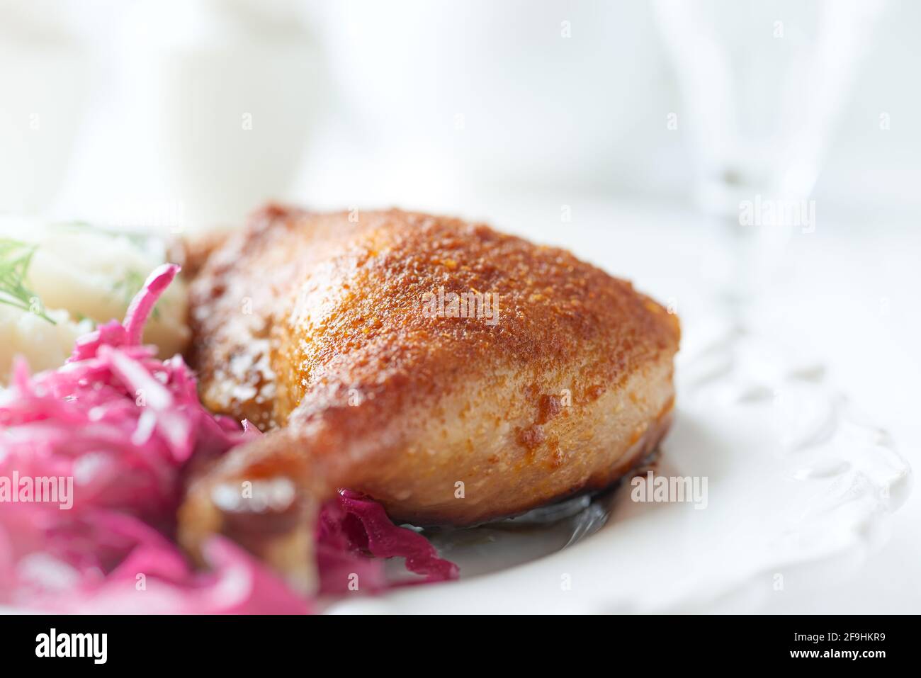 Roast duck with red cabbage and mashed potatoes on bright background ...