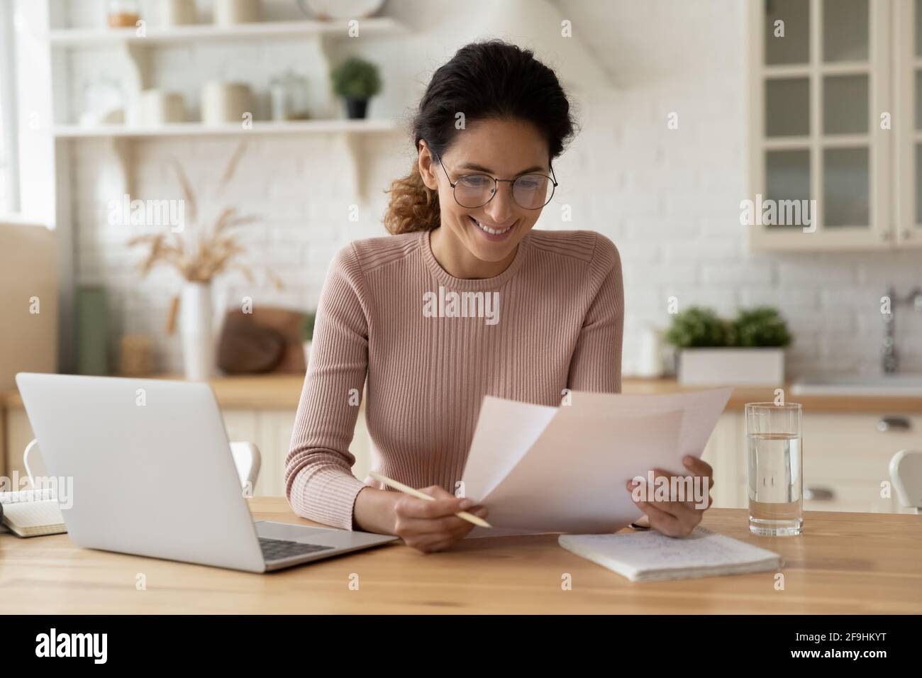 Happy millennial hispanic lady review printed paper documents financial ...