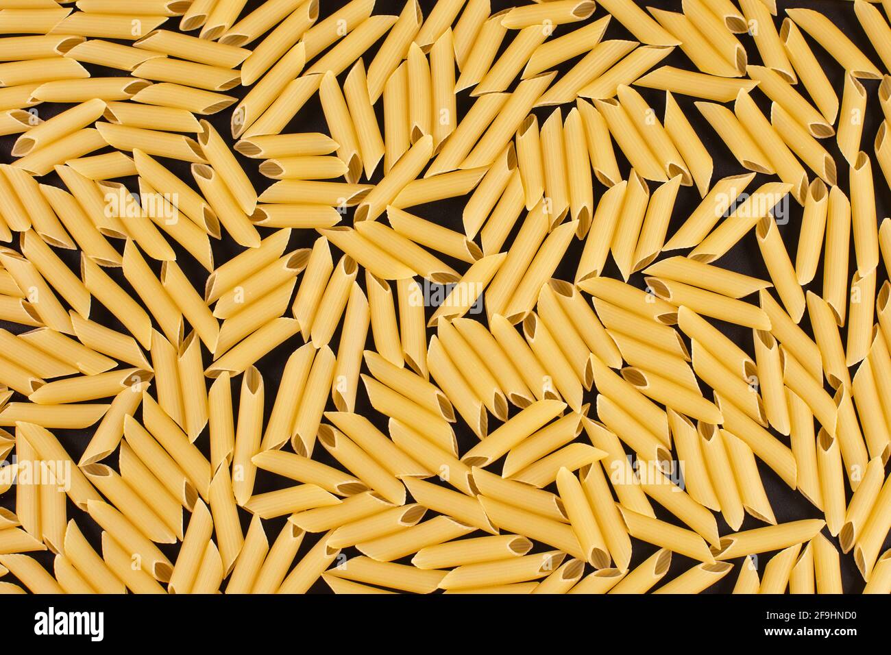 Italian Macaroni Pasta Penne Rigate raw food background or texture ...