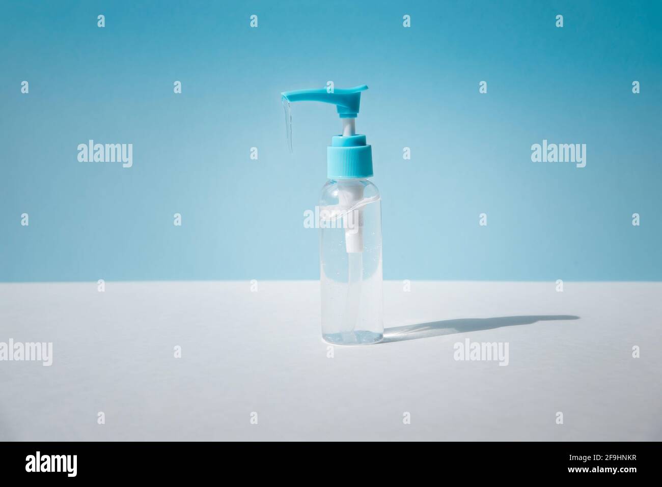 Dispenser with transparent gel against a light blue background Stock ...