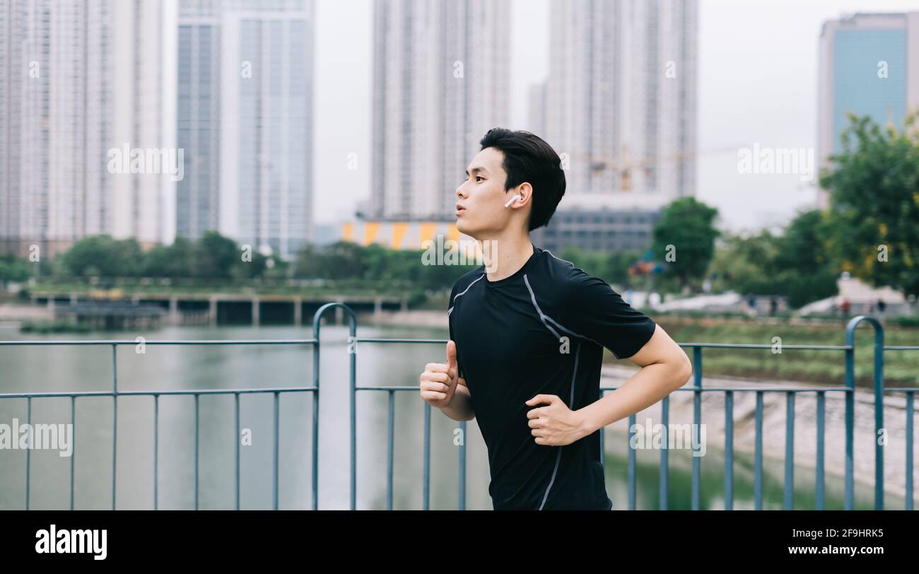 Young chinese man jogging in the park hi-res stock photography and ...