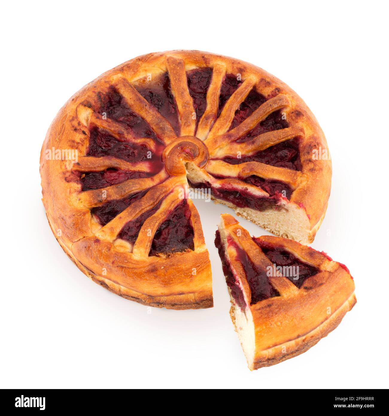 Round pie with fruit jam filling and sliced piece isolated on white ...