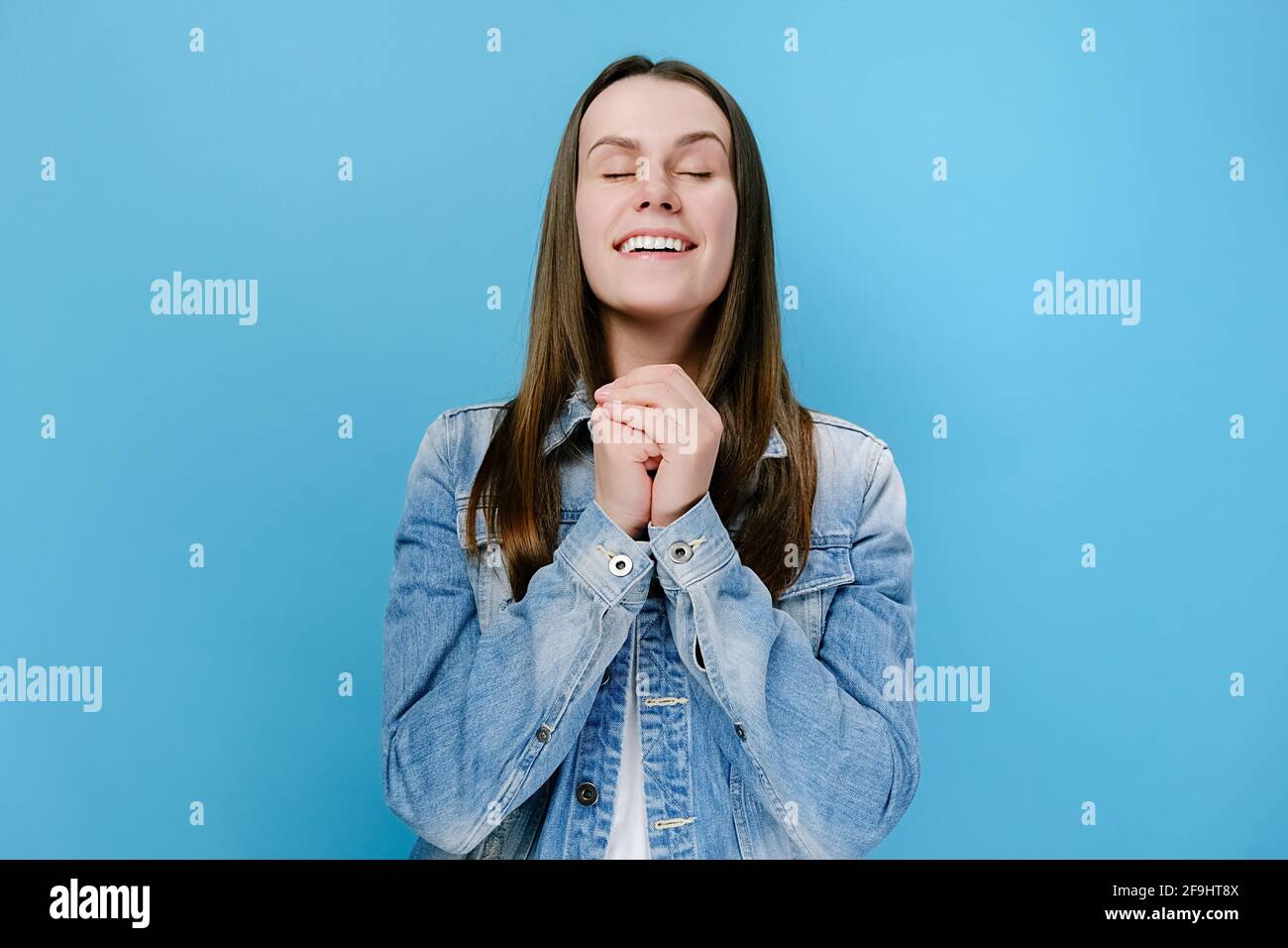 Hopeful young female clenching fists making wish praying asking dreams ...