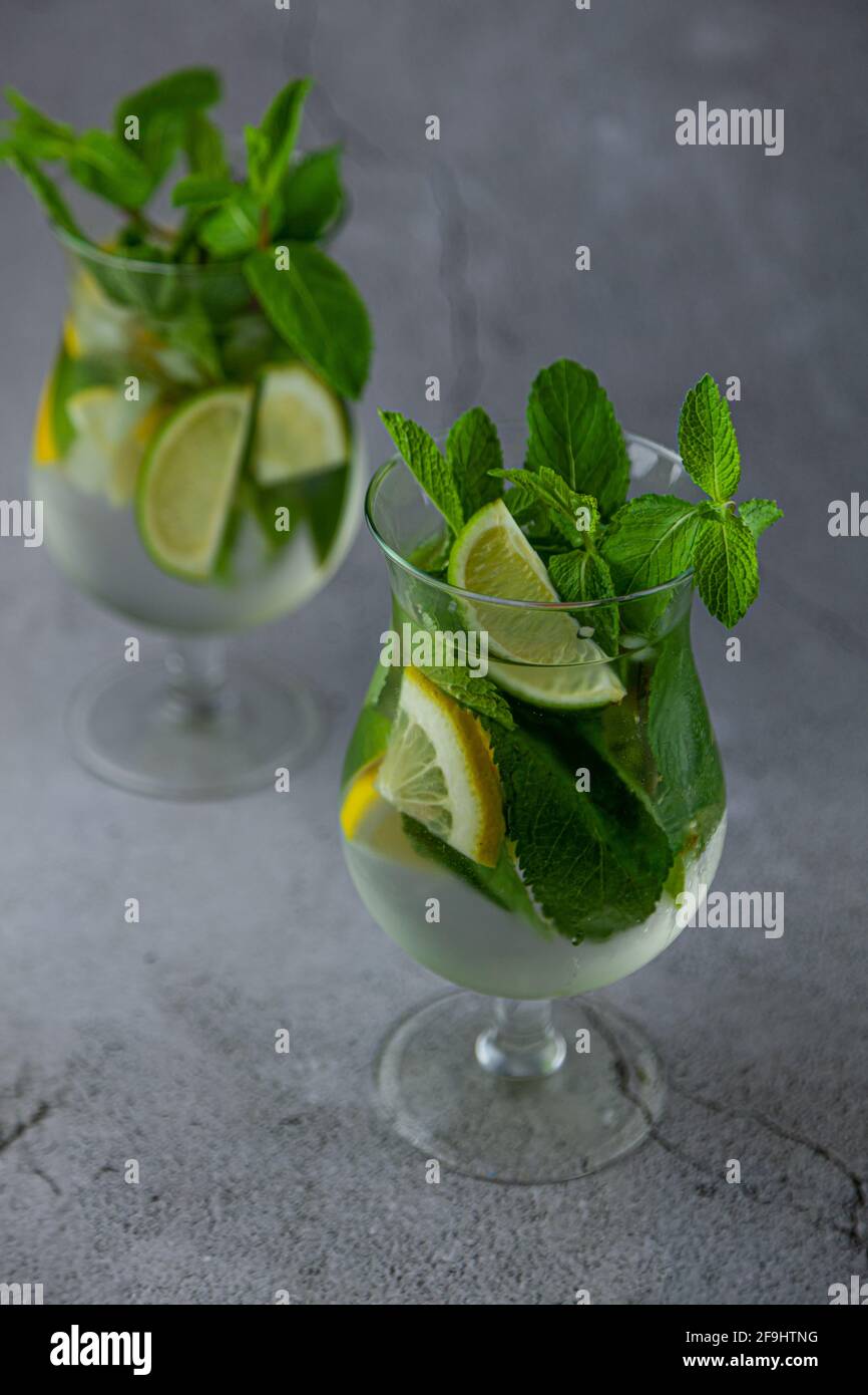 Summer mint lime refreshing cocktail mojito with rum and ice in glass ...