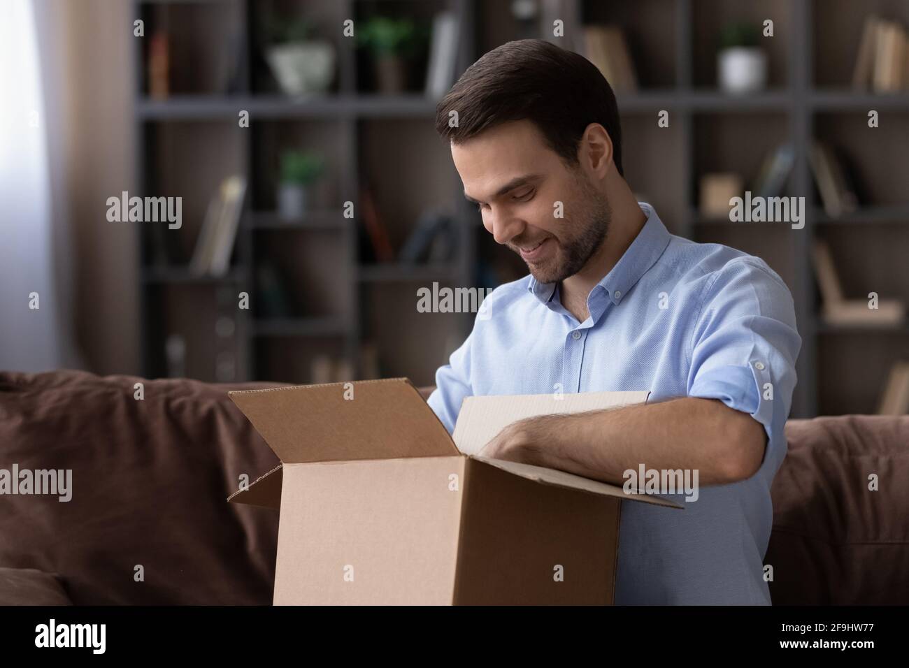 Happy male customer unpack hi-res stock photography and images - Alamy
