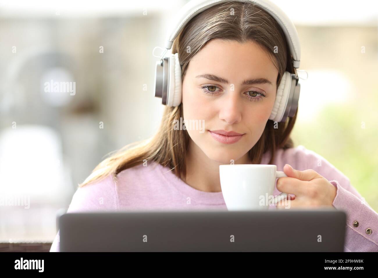 Front view portrait of a mindfulness woman watching media on laptop in ...