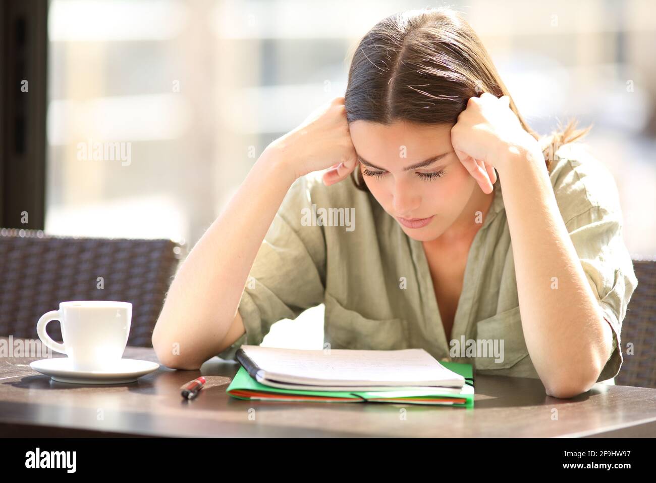 Studious student studying reading notes sitting in a coffee shop Stock ...