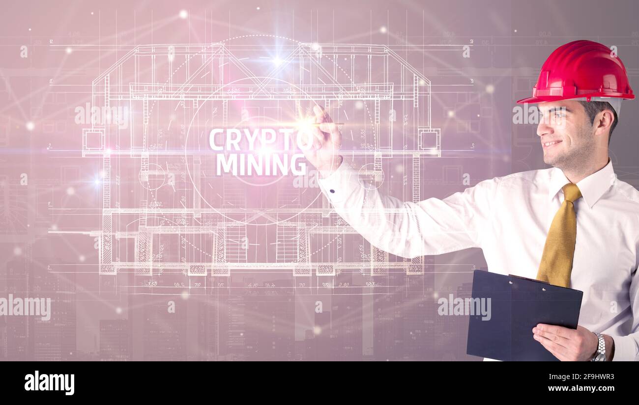 Handsome architect drawing with helmet Stock Photo - Alamy