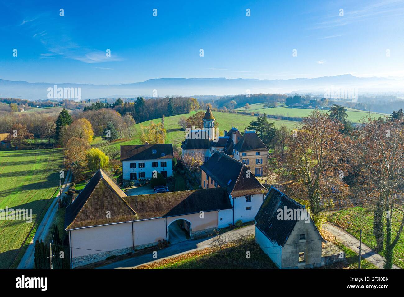 Drone shot of a village, featuring agriculture land with houses ...