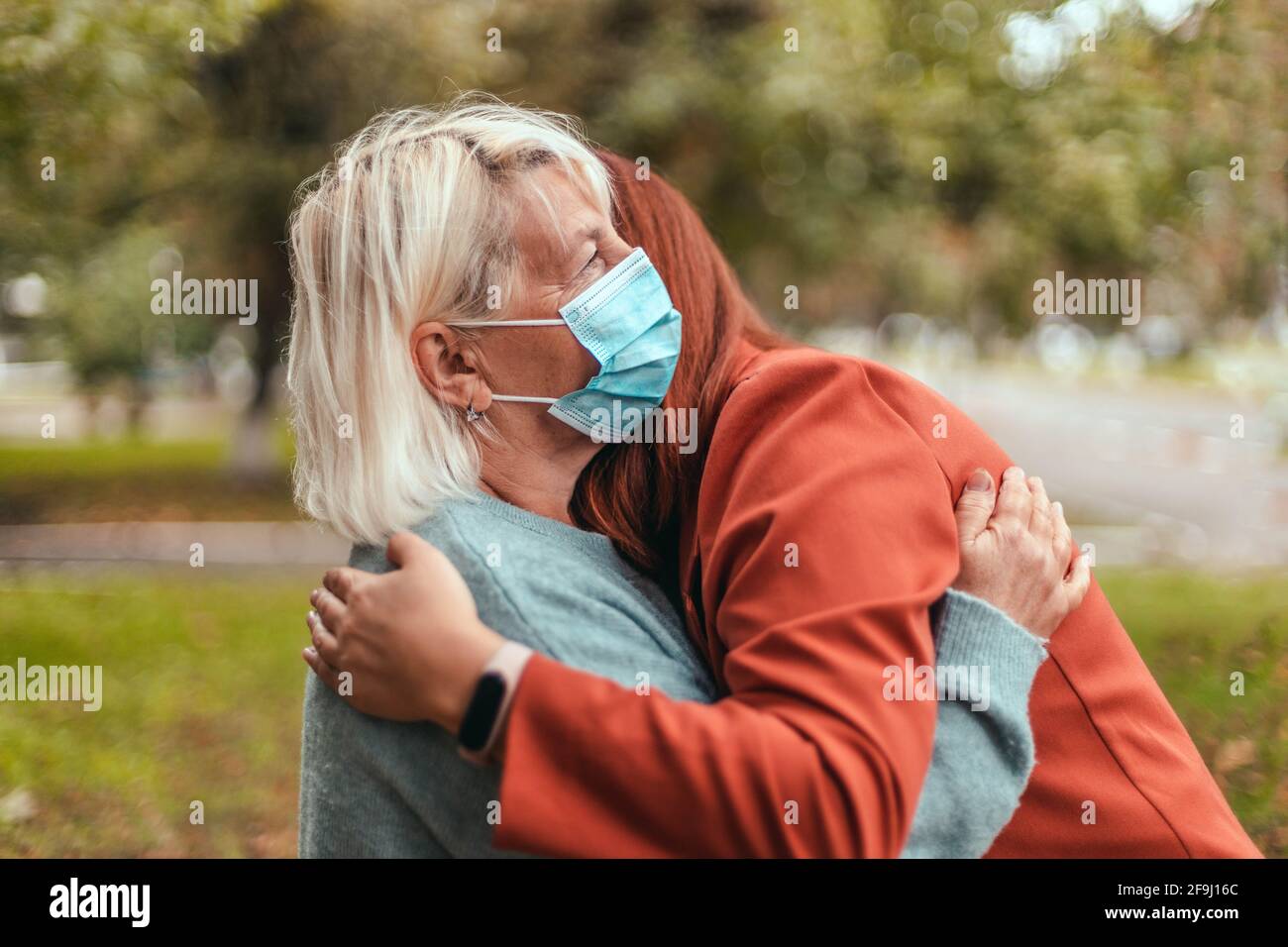 Two women hugging in the park. Mother and daughter with protective ...