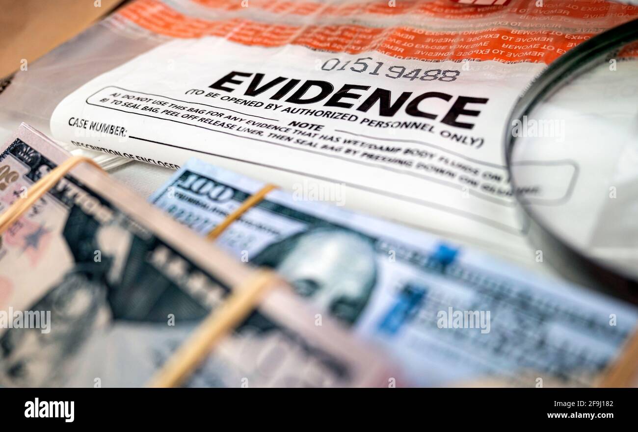 Evidence bag next to dollar banknotes in a crime investigation unit ...