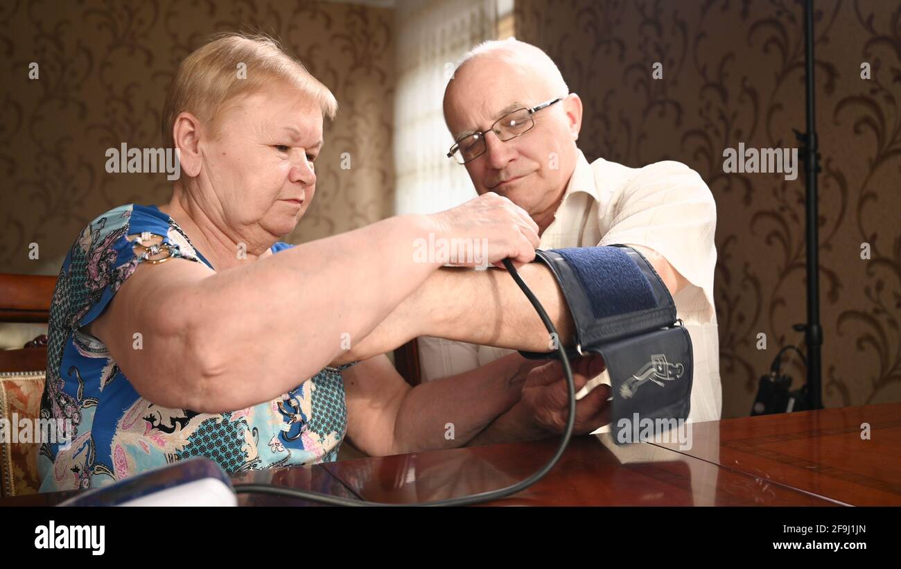 Husband measuring wife blood pressure hi-res stock photography and ...