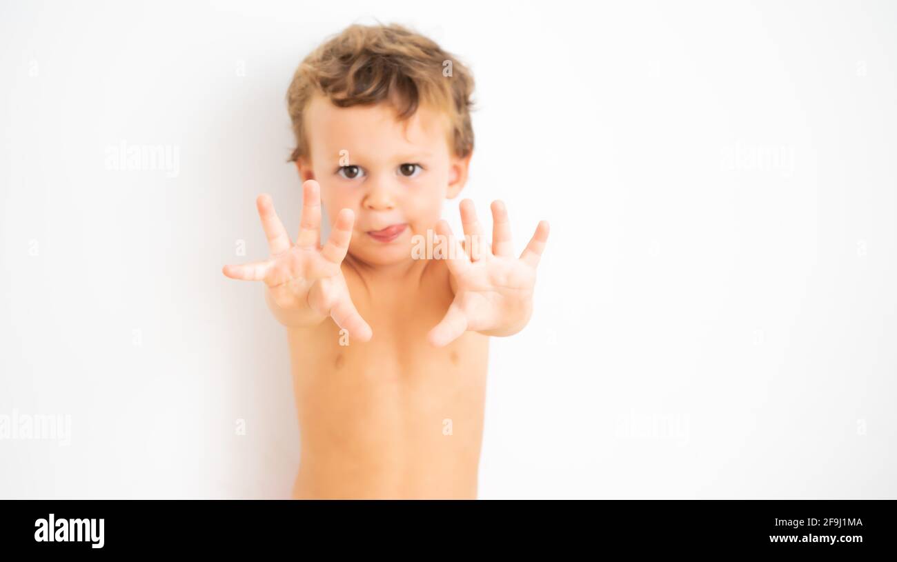 Portrait of caucasian child with arms outstretched showing hands, on ...