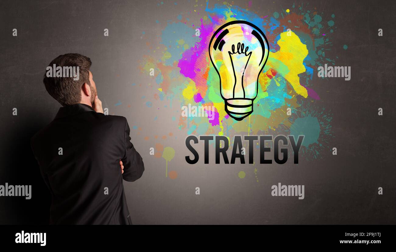 businessman drawing colorful light bulb Stock Photo - Alamy