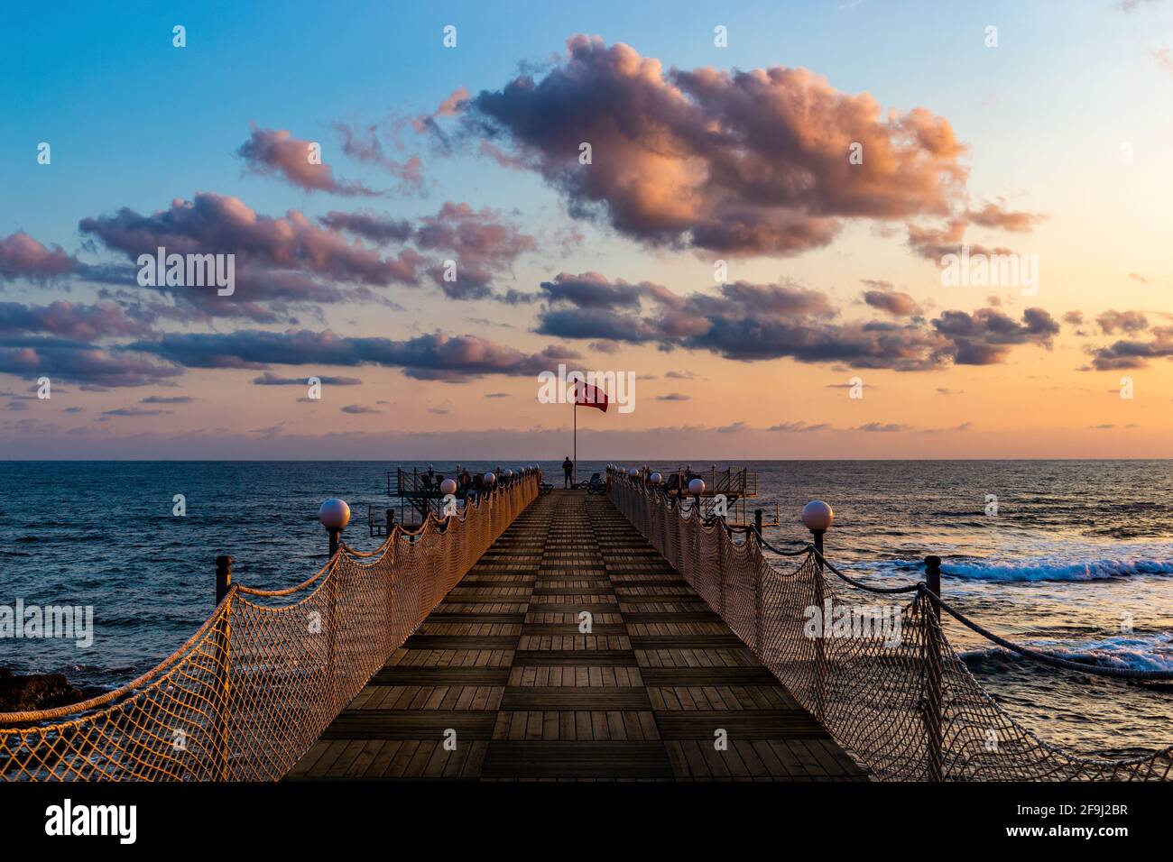 Wooden pier and sunset over sea Stock Photo - Alamy