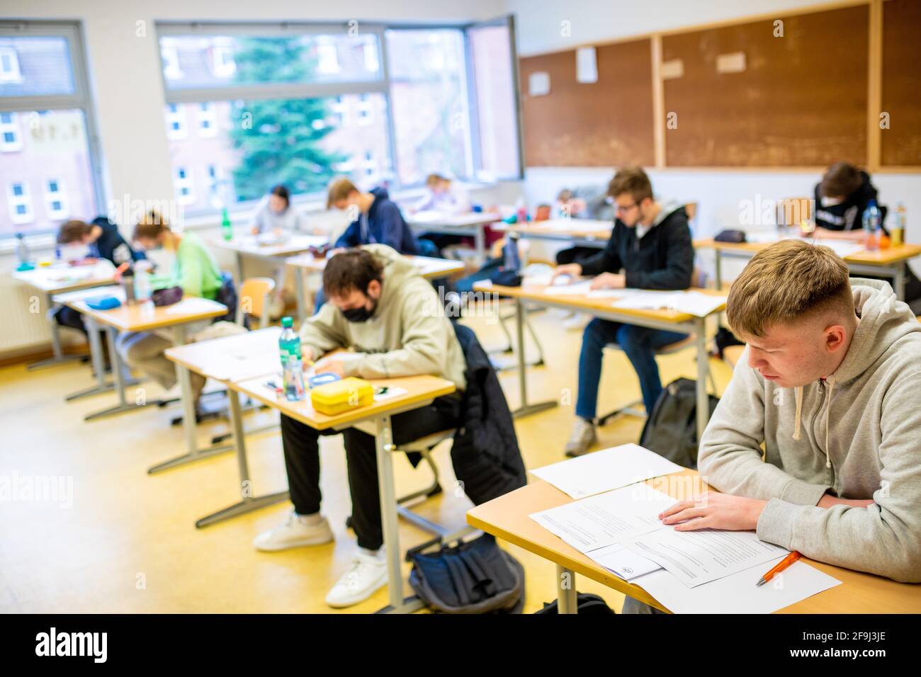 Wedemark, Germany. 19th Apr, 2021. Pupils write their final exams in ...