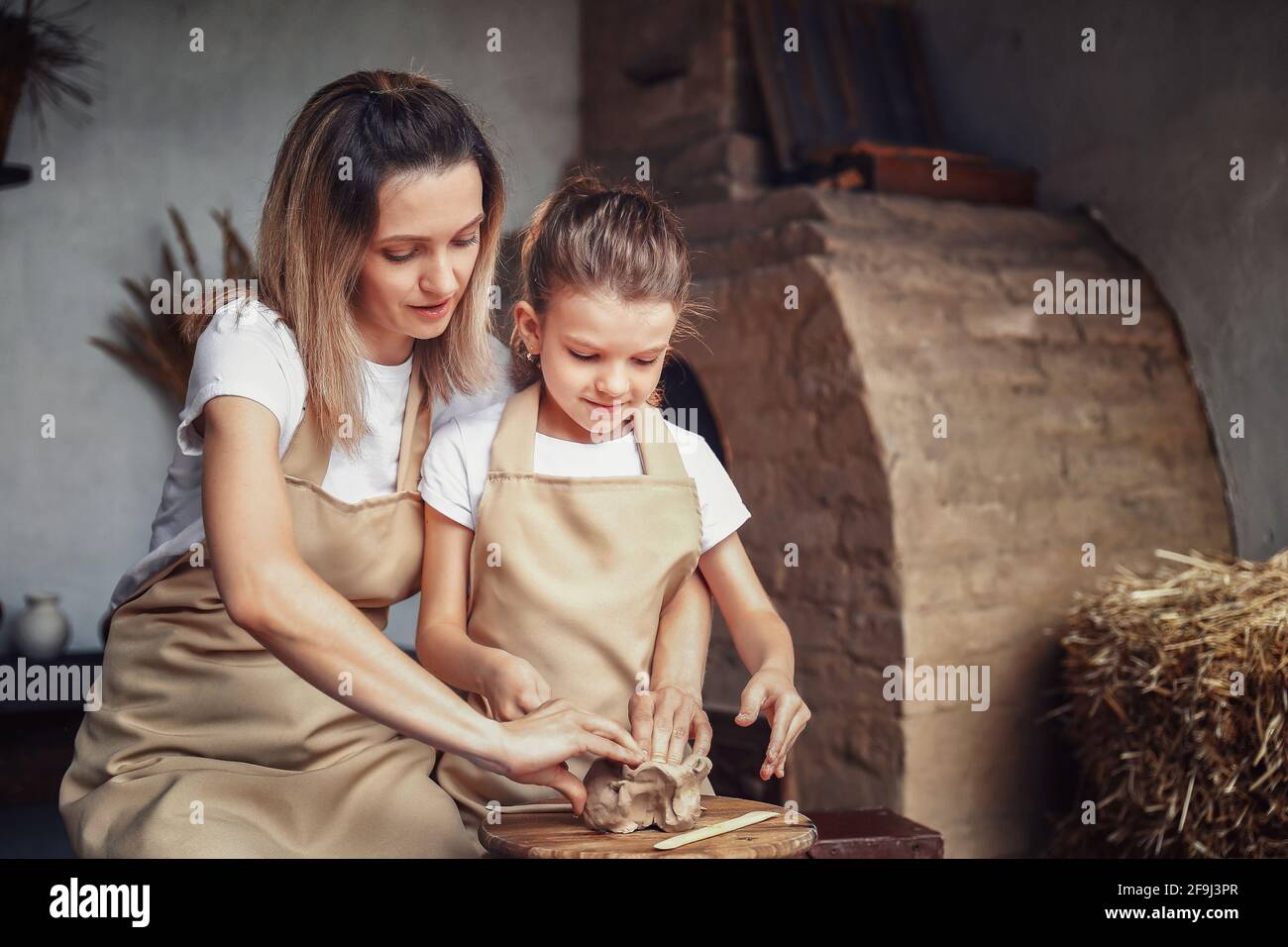 mother and daughter mold with clay, enjoying pottery art and pro Stock ...