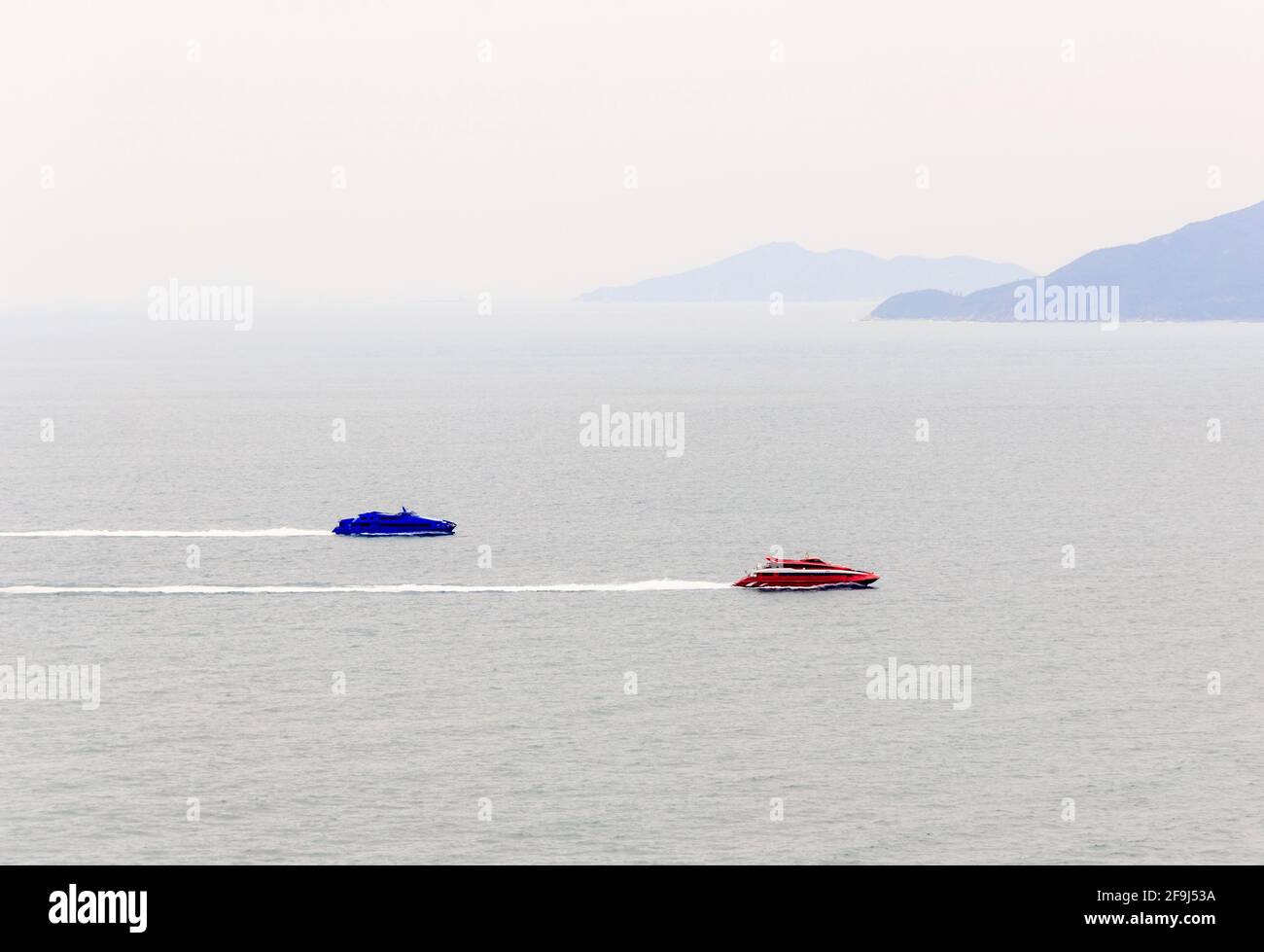A red and blue jet boats move fast on the sea Stock Photo - Alamy