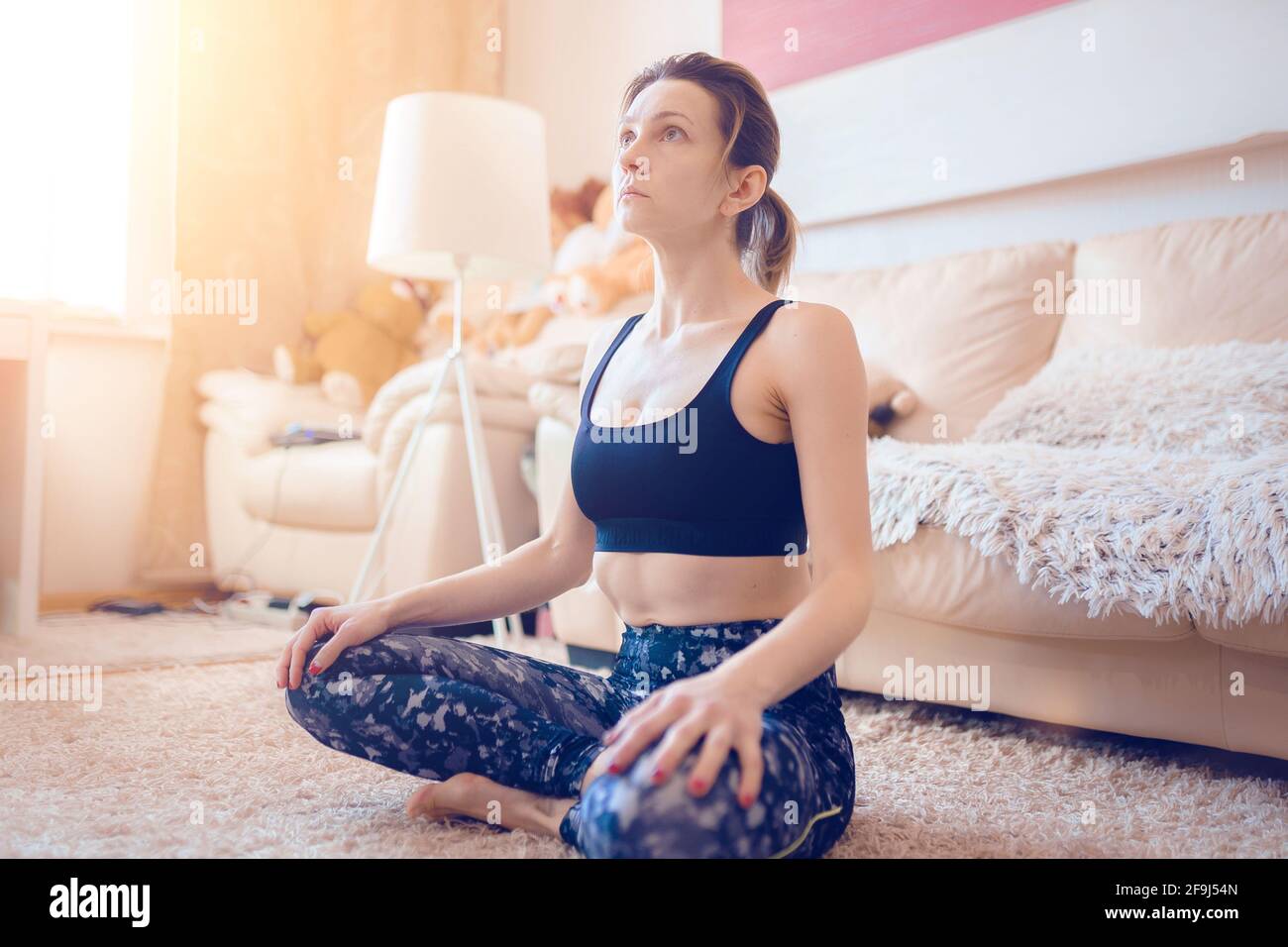 Woman is practicing yoga, gymnastic exercises for neck while sit Stock ...