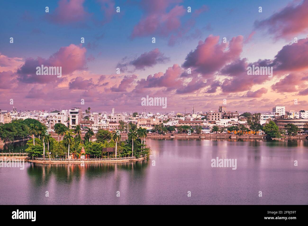 Shot of a city near sea in purple sunset Stock Photo - Alamy