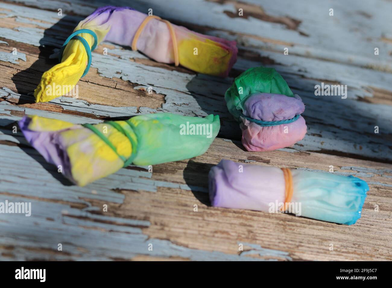 Close up shot of folded fabric soaked in color to create a batik ...