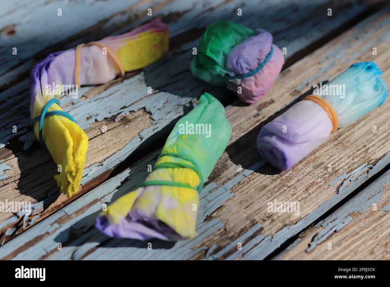 Close up shot of folded fabric soaked in color to create a batik ...