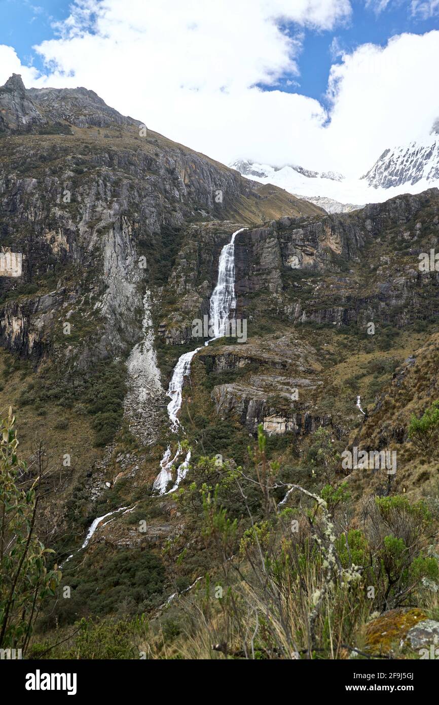 Vertical shot of a small waterfall in Huascaran National Park Huallin ...