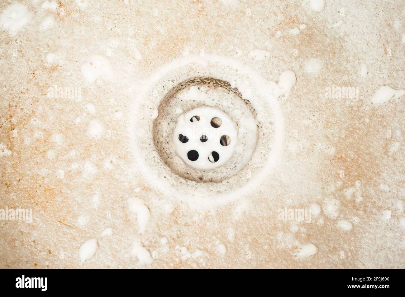 An attempt to wash the fat from the kitchen sink with a foamy detergent ...