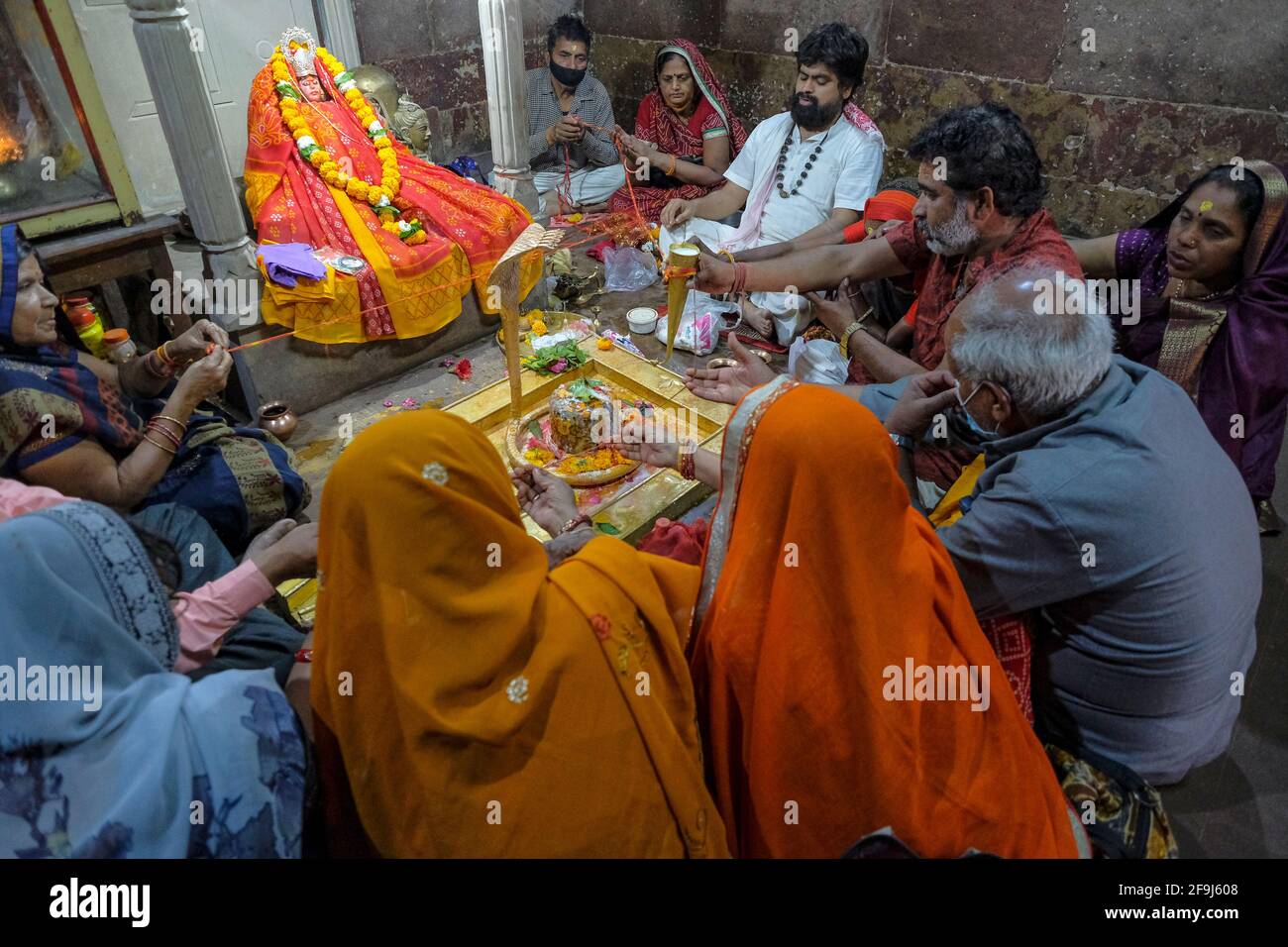 Omkareshwar, India - March 2021: A family making an offering at the ...