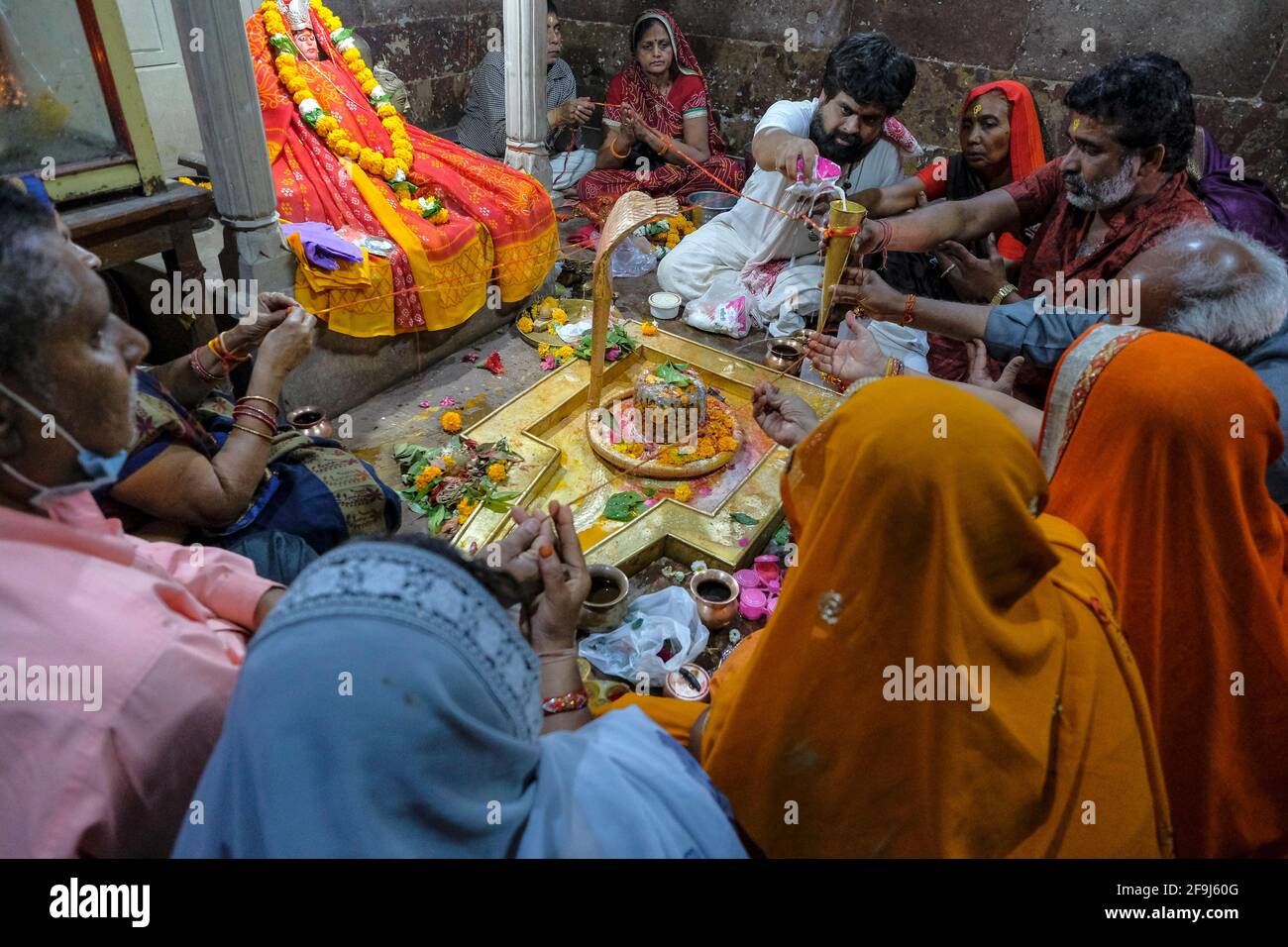 Omkareshwar, India - March 2021: A family making an offering at the ...