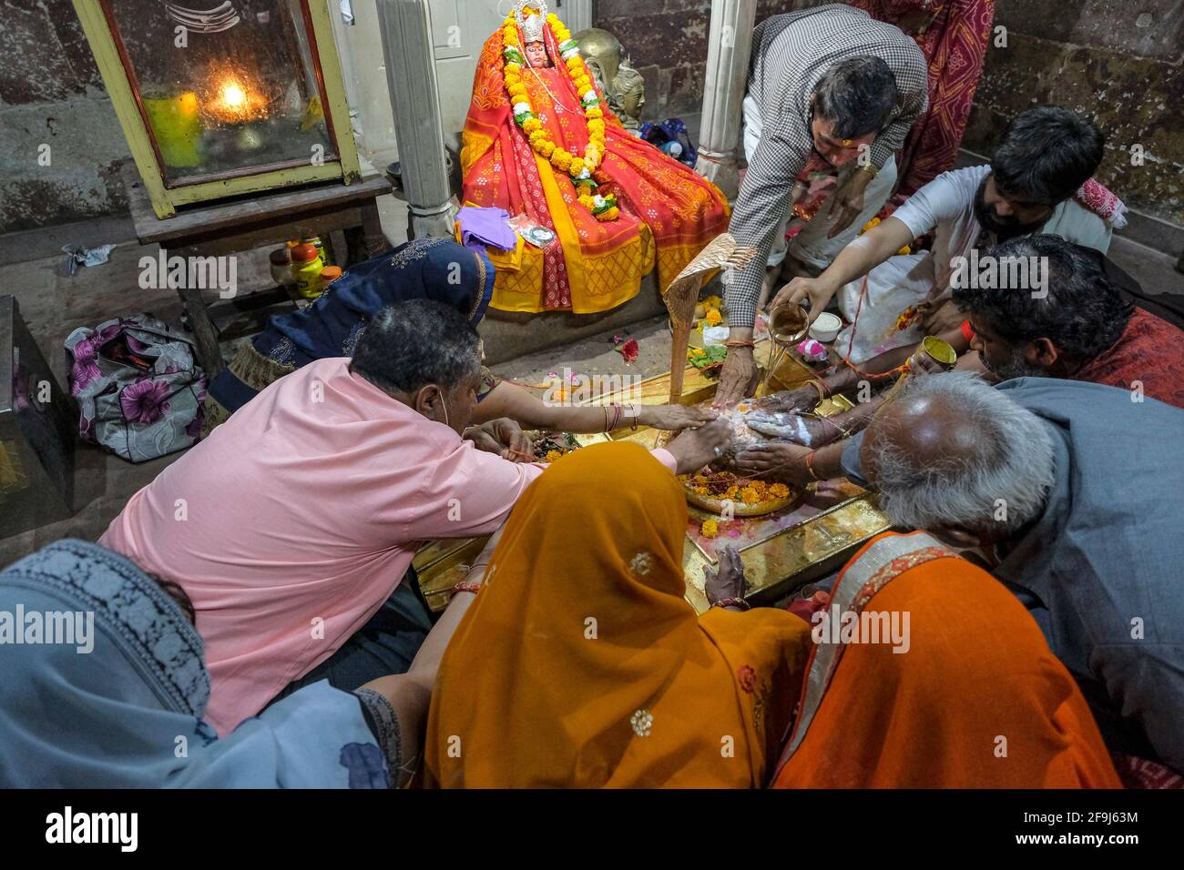 Omkareshwar, India - March 2021: A family making an offering at the ...