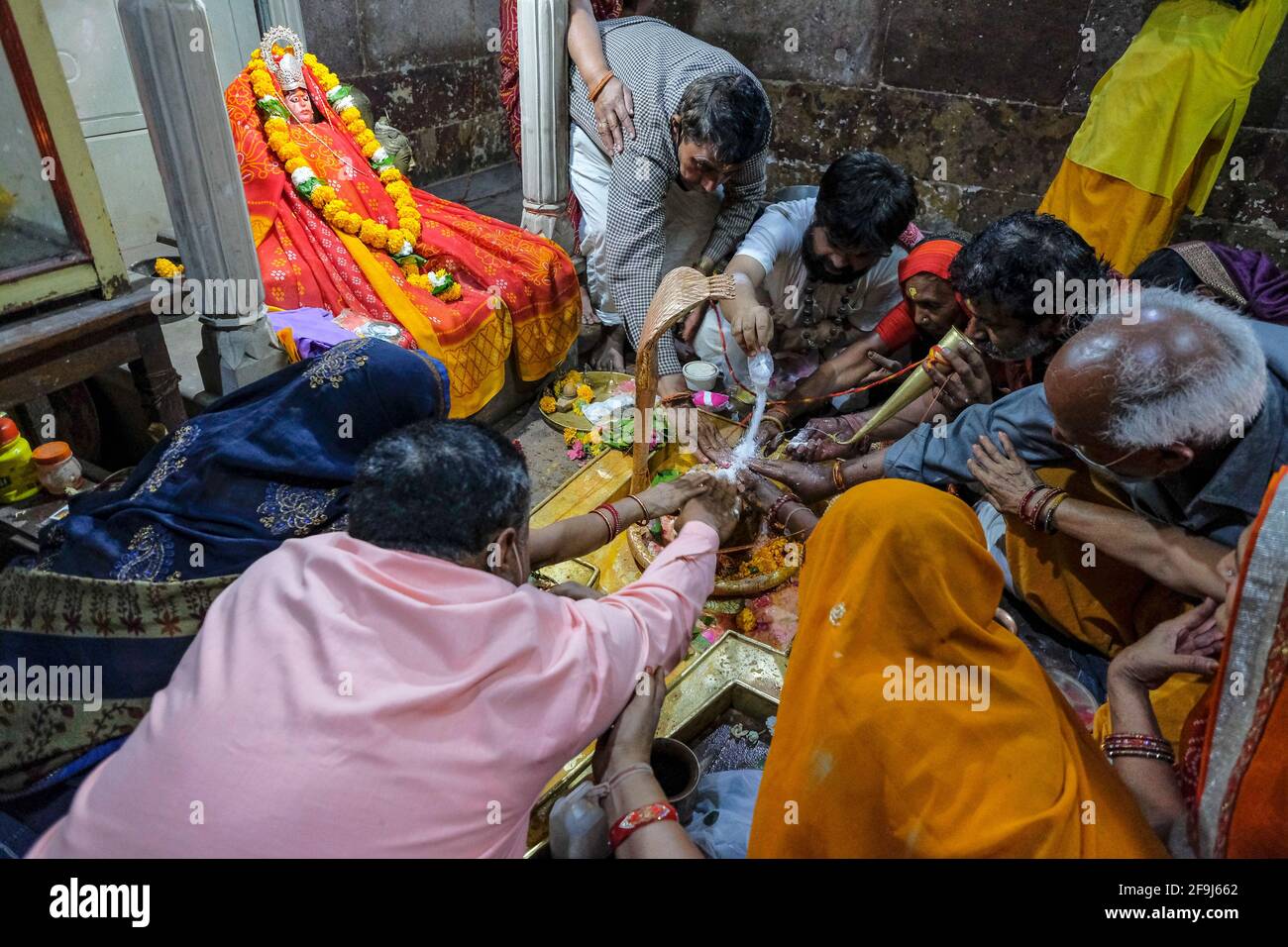 Omkareshwar, India - March 2021: A family making an offering at the ...