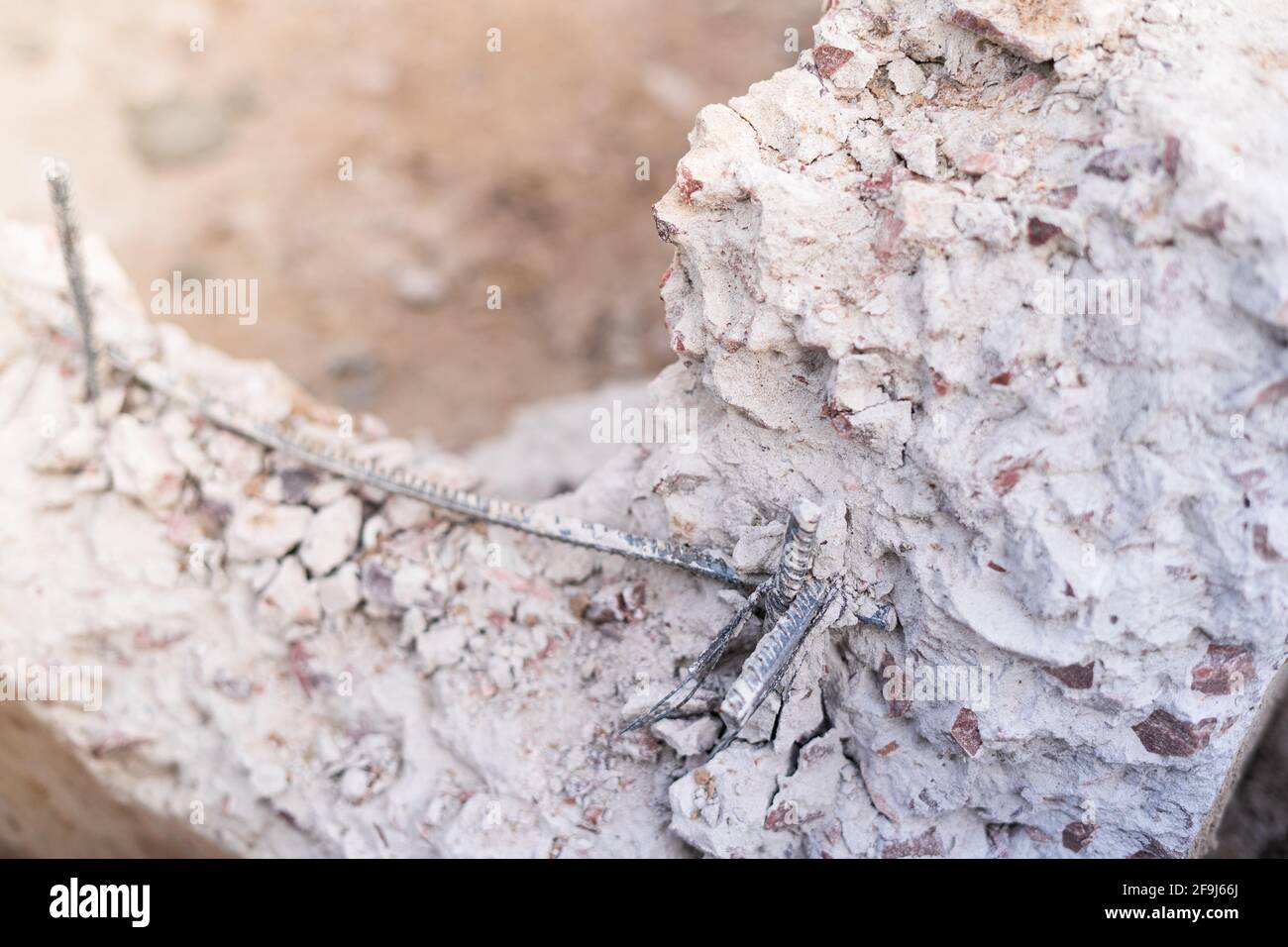Collapsed concrete structure with protruding reinforcement close-up ...