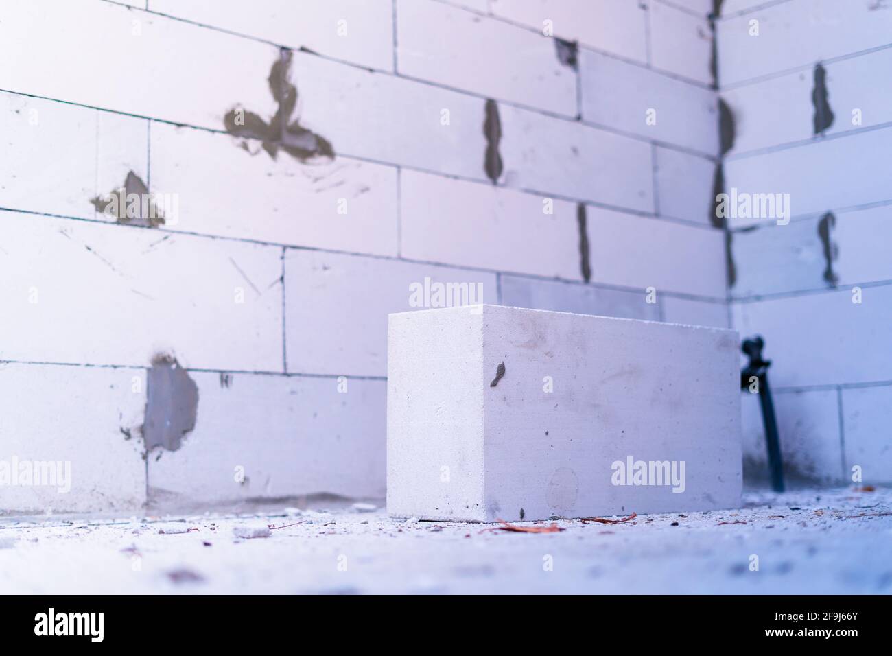 A large rectangular building aerated concrete block lies against the ...