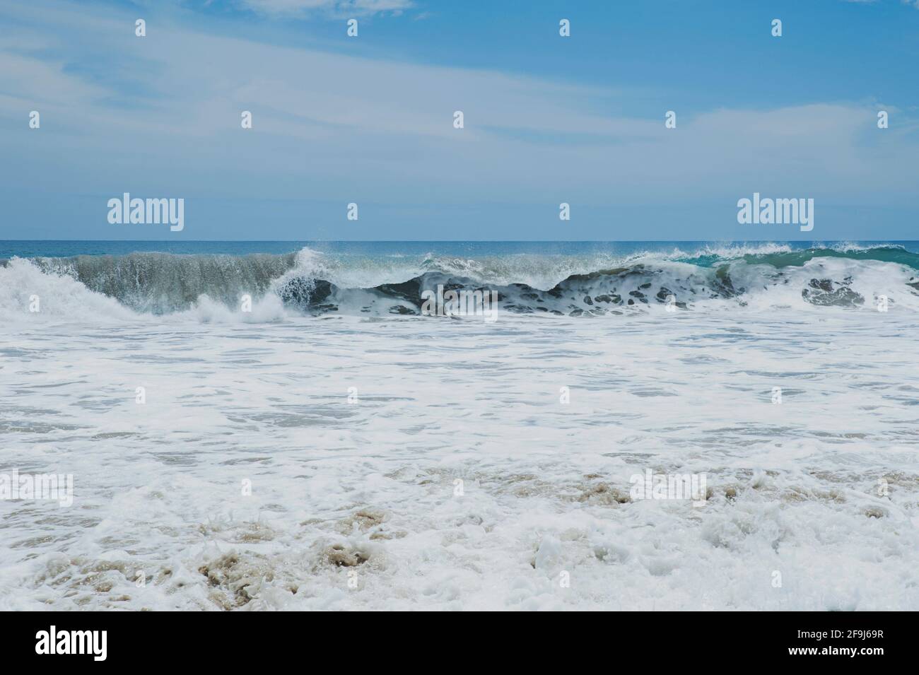 Frothy waves breaking on Maspalomas beach, a vast white sand beach in ...