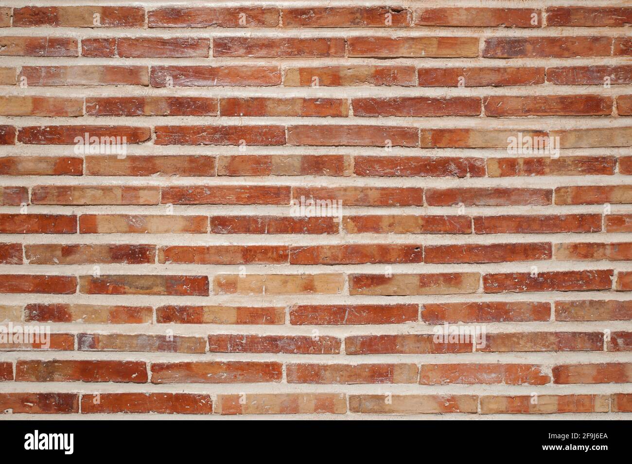 Rough, aged brick wall laid in running bond style, classic one-over-two ...